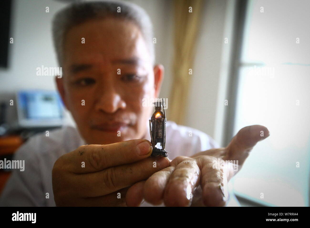 60-year-old Chinese lights and lamps collector Wang Fuhe shows his ...