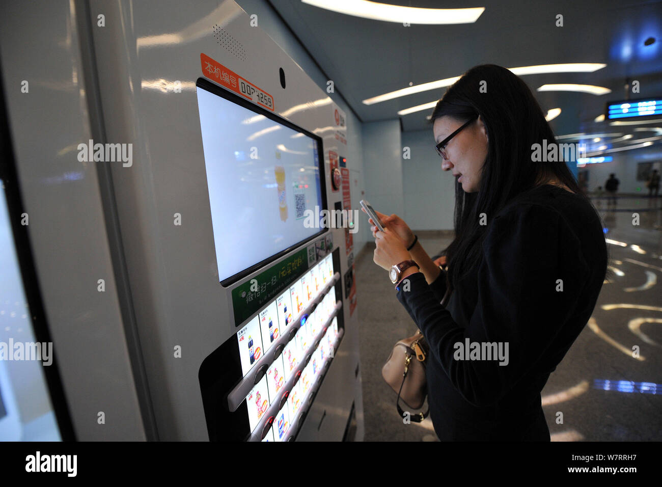 --FILE--A Chinese mobile phone user scans a QR code via mobile payment ...