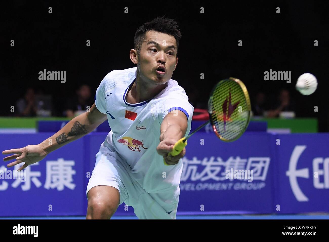 Lin Dan of China returns a shot to Chen Long of China in their final ...