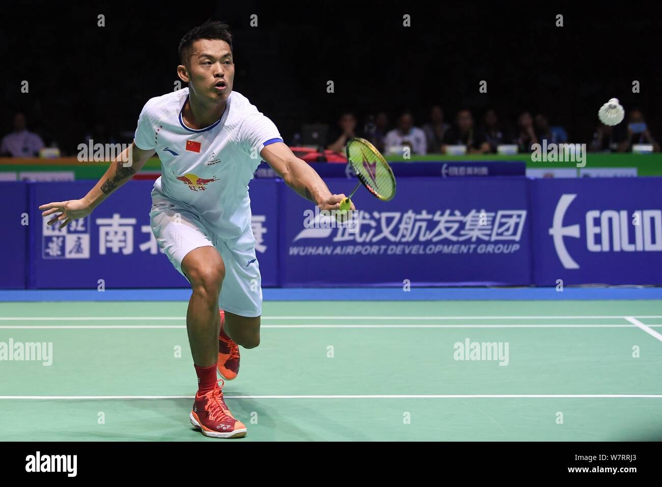 Lin Dan of China returns a shot to Chen Long of China in their final ...