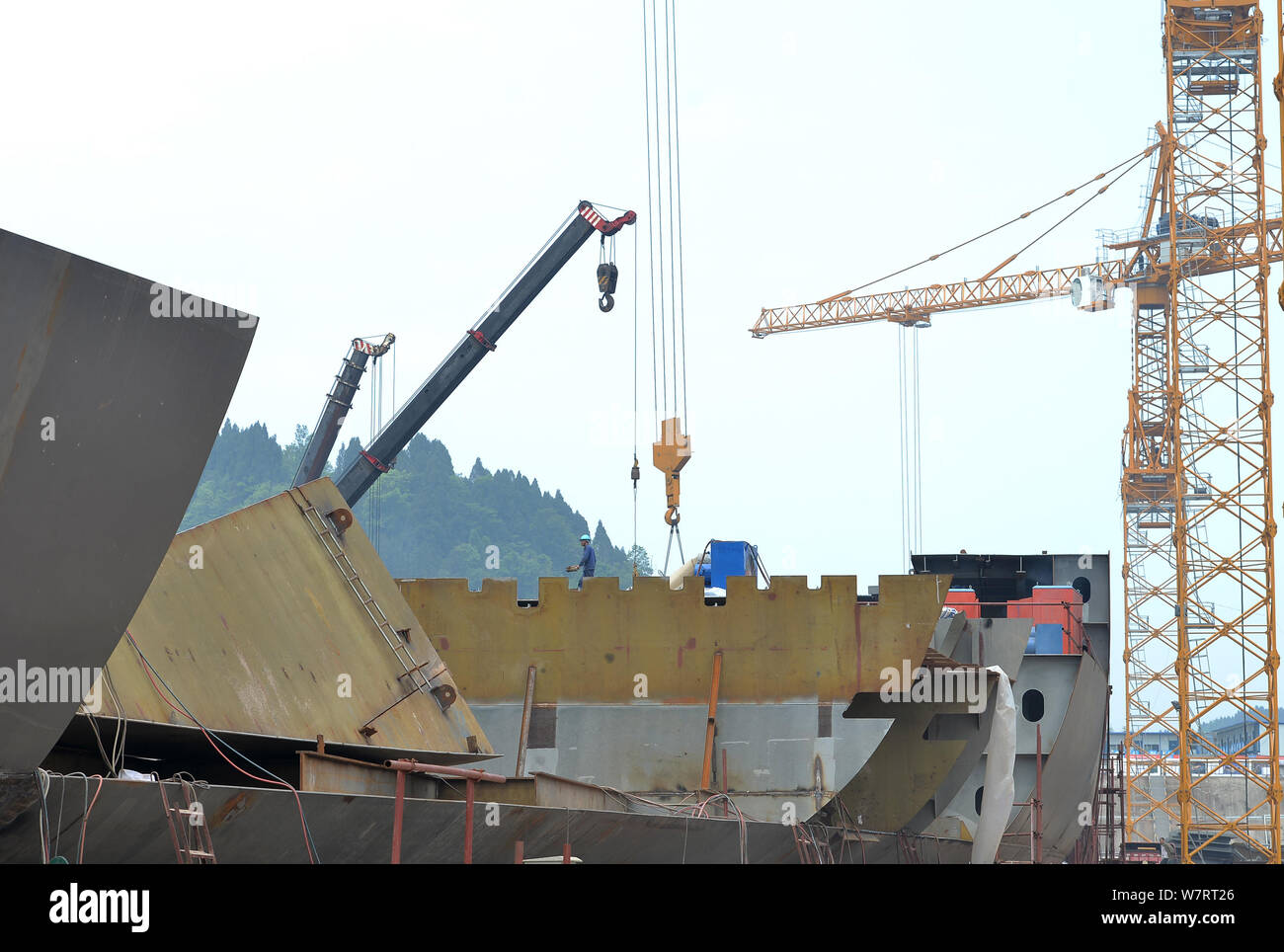 Chinese workers labor at the construction site of a full-scale replica ...