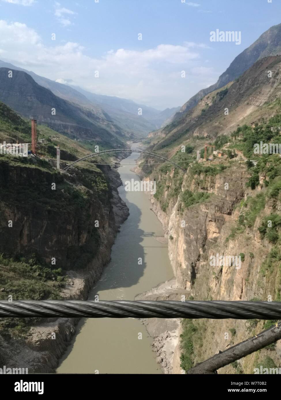 Aerial view of a bridge being built over the Jinshajiang River to ...