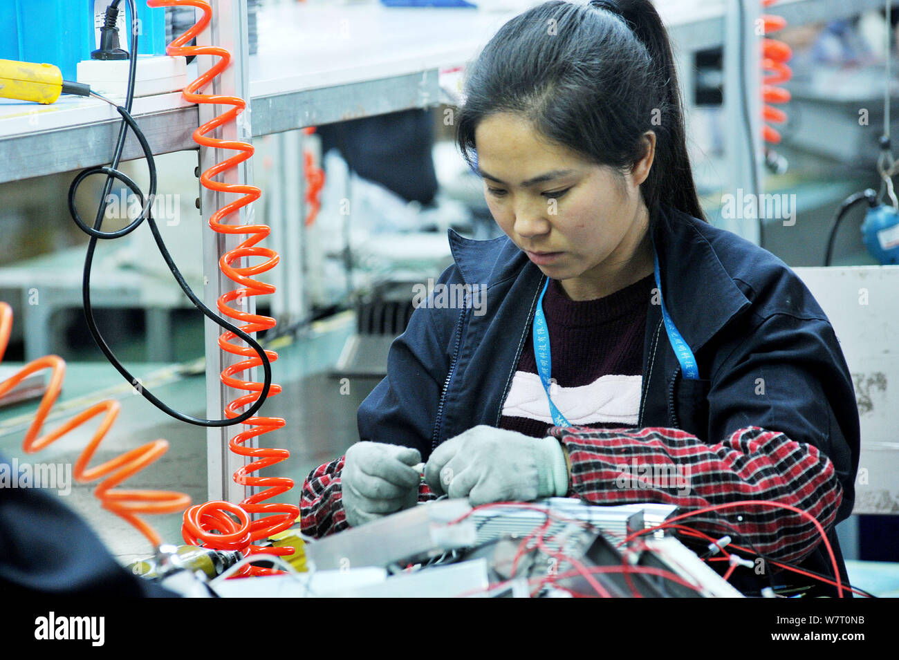 --FILE--A female Chinese worker makes LED Lights to be exported at a ...