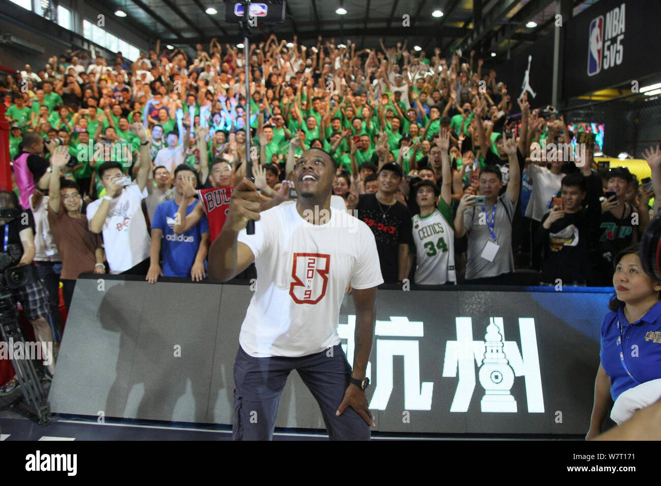 Retired American basketball player Paul Pierce, front, poses for photos ...