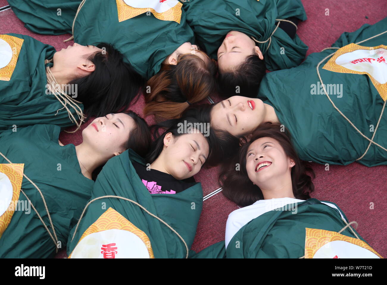 University students wrapped up as zongzi or glutinous rice dumplings ...