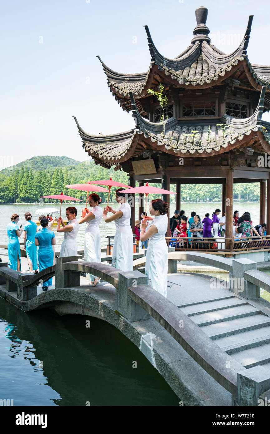 Women from different countries dressed in cheongsam, also known as ...