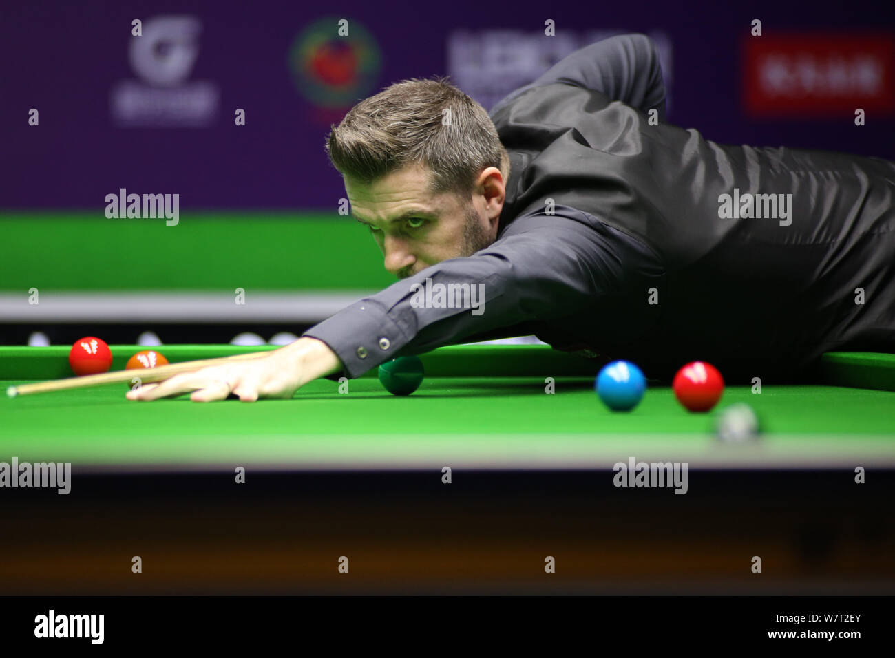 Mark Anthony Selby of England plays a shot to Ben Woollaston of England ...