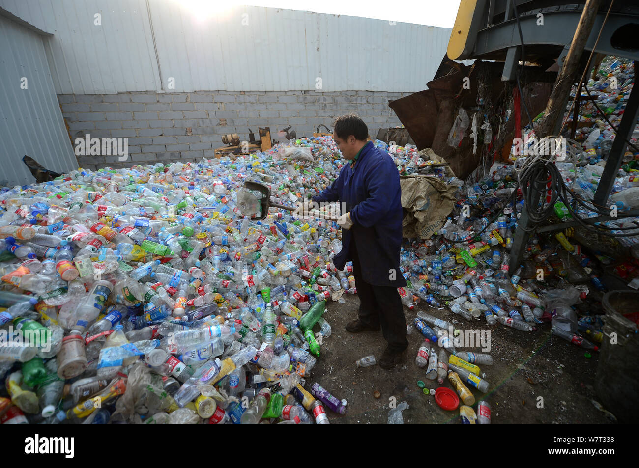 A Chinese worker clears plastic bottles at the plastic bottle recycling ...