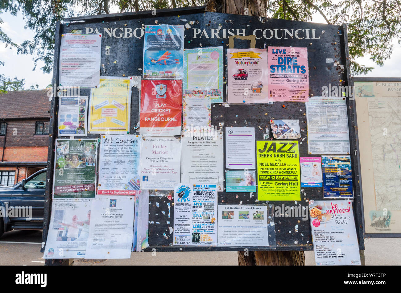 A noticeboard in Pangboure, West Berkshire, UK which is covered with ...