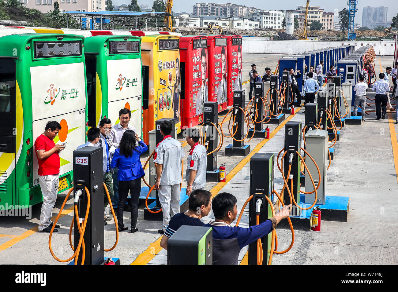 --FILE--Chinese workers are pictured at a bus charging station in ...