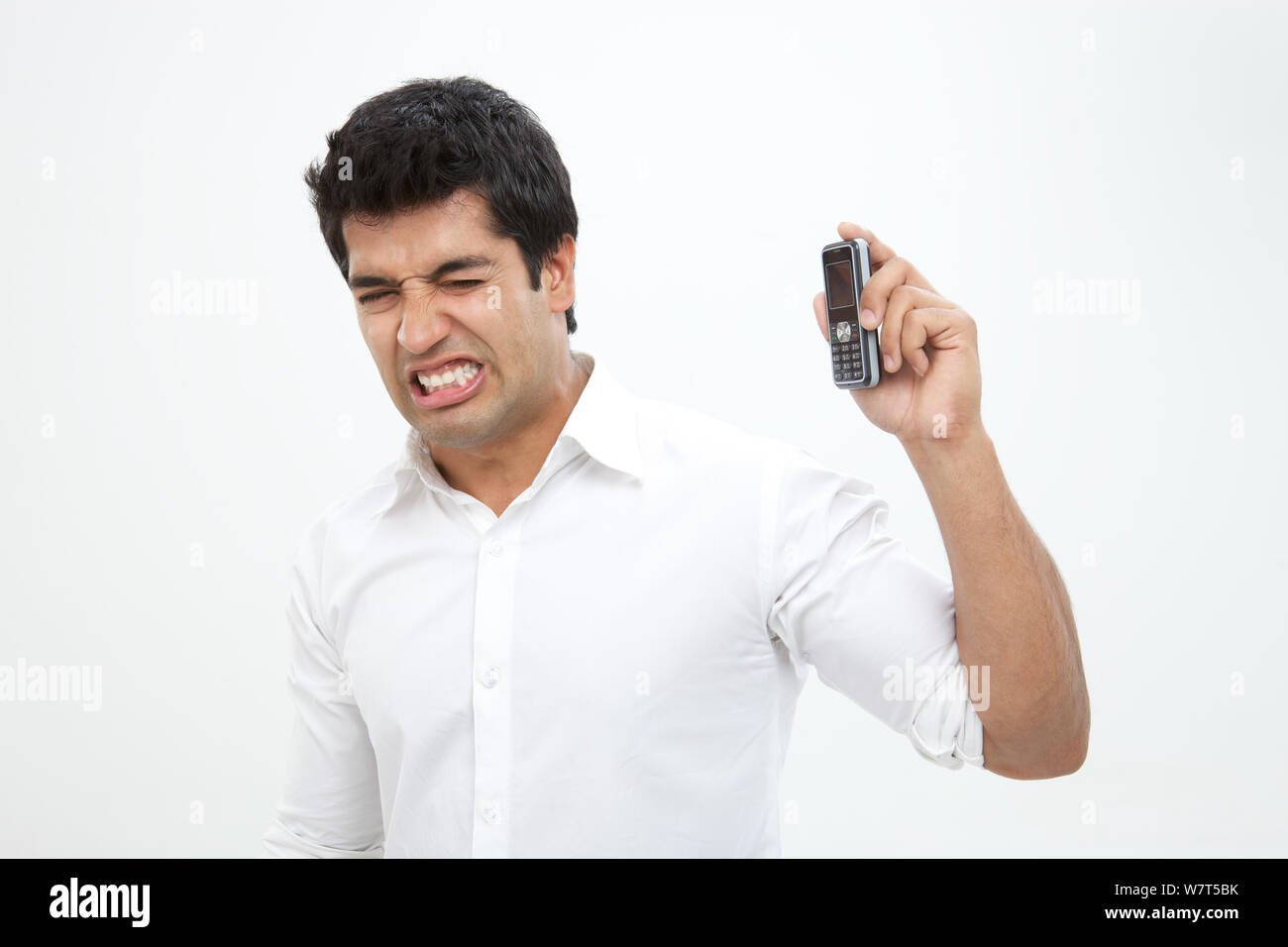 Young man holding mobile phone Stock Photo - Alamy