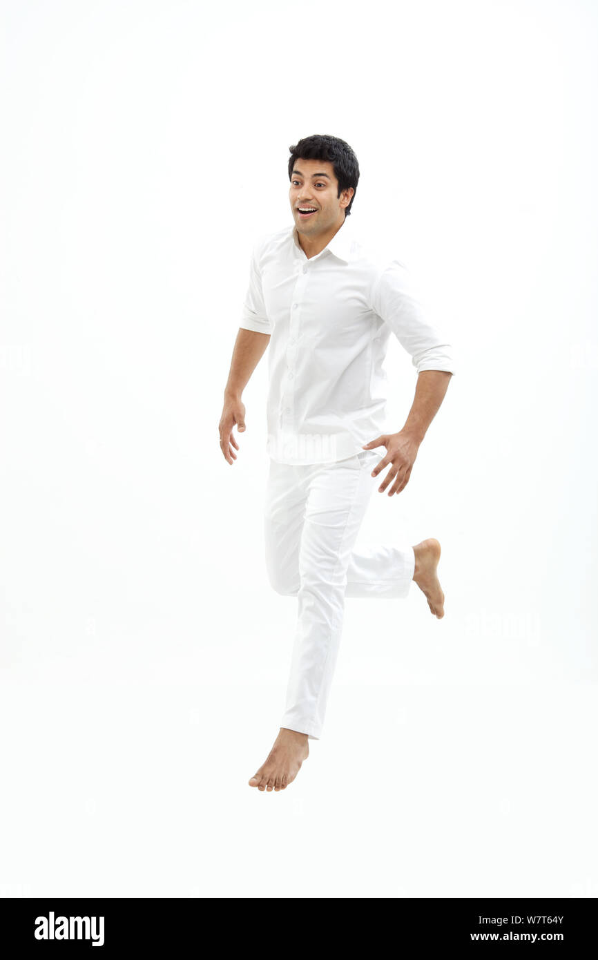 Young man jumping in mid air Stock Photo - Alamy