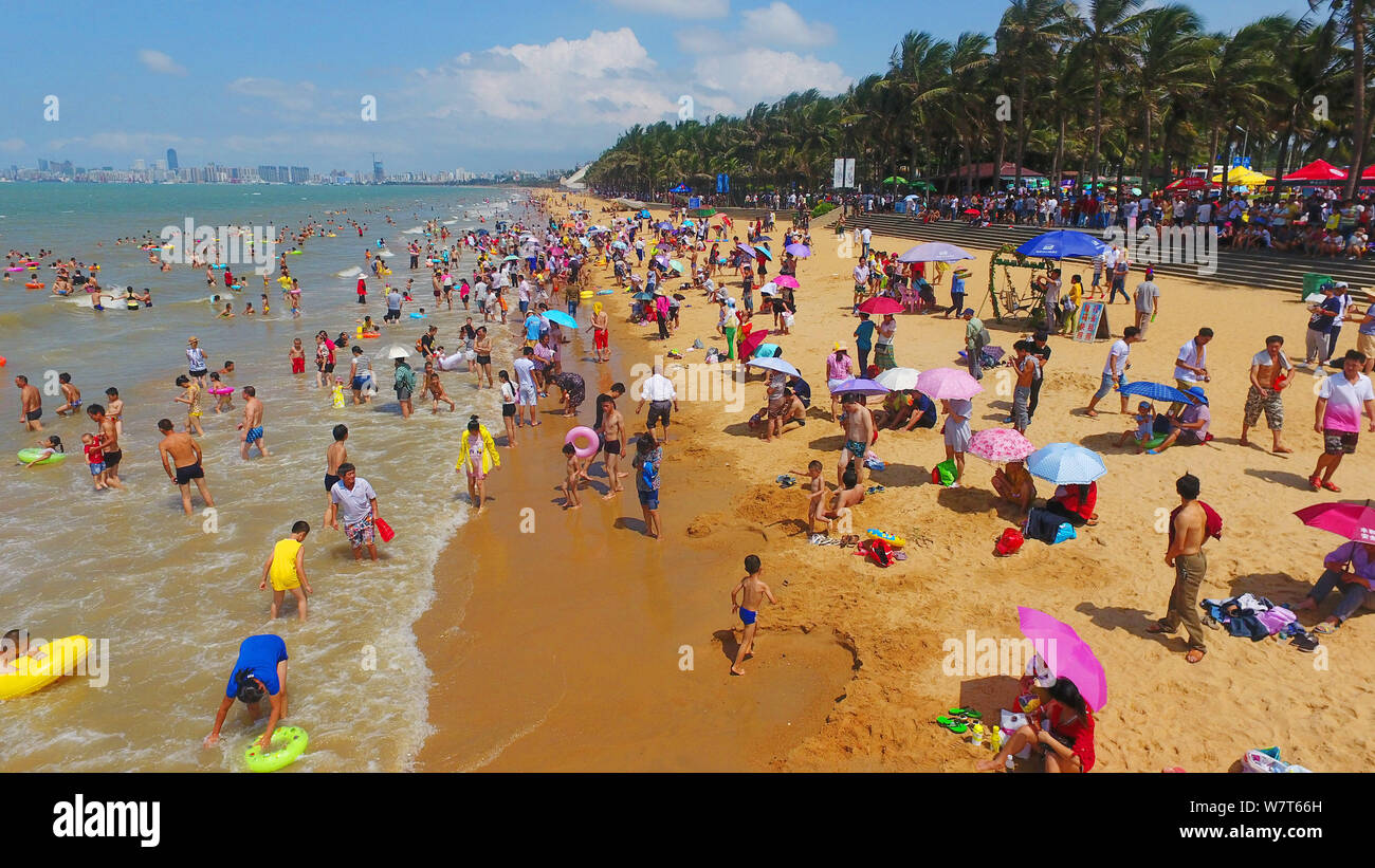 Tourists crowd a beach resort during the Duanwu Festival, or the Dragon ...