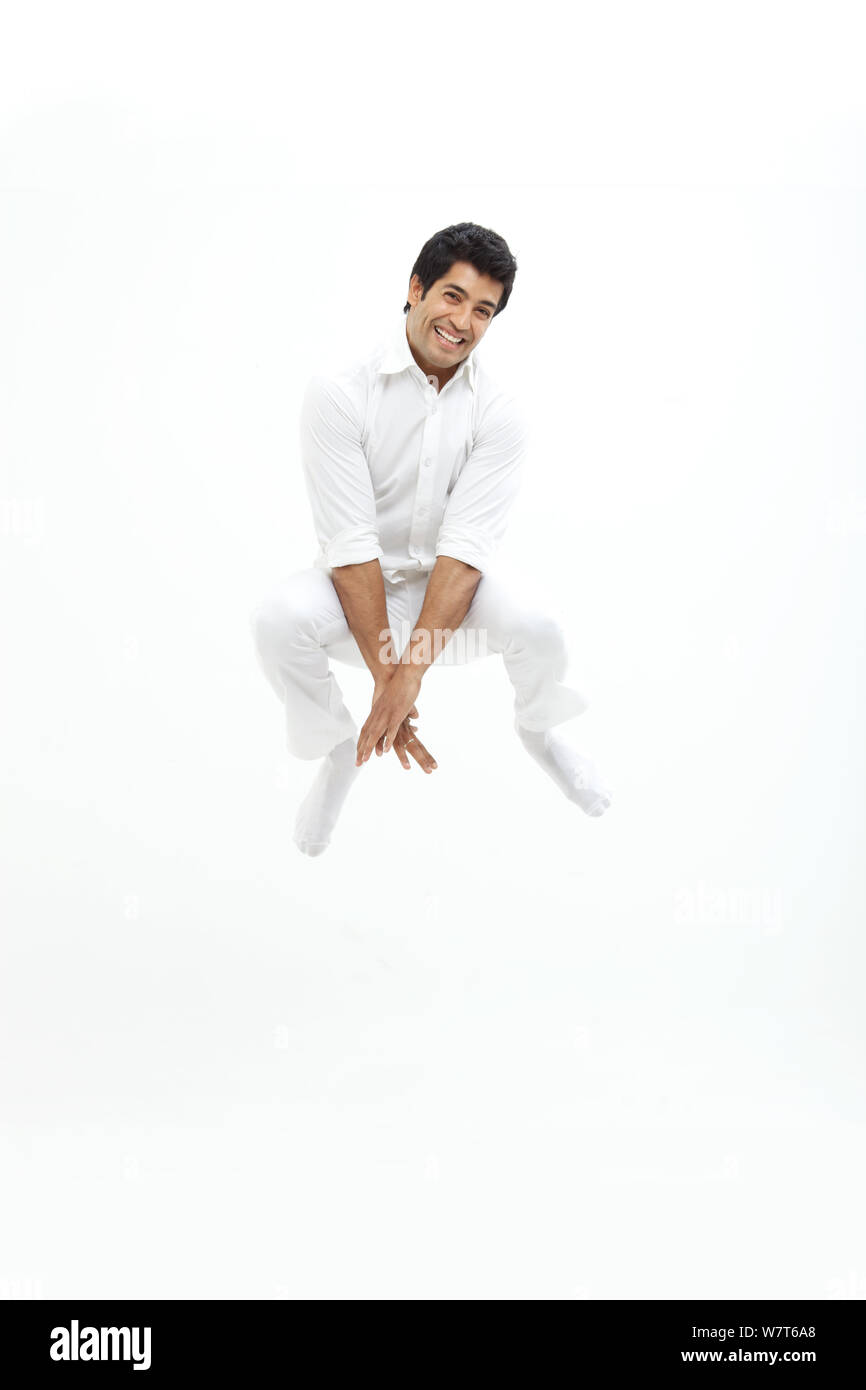 Young man jumping in mid air Stock Photo - Alamy