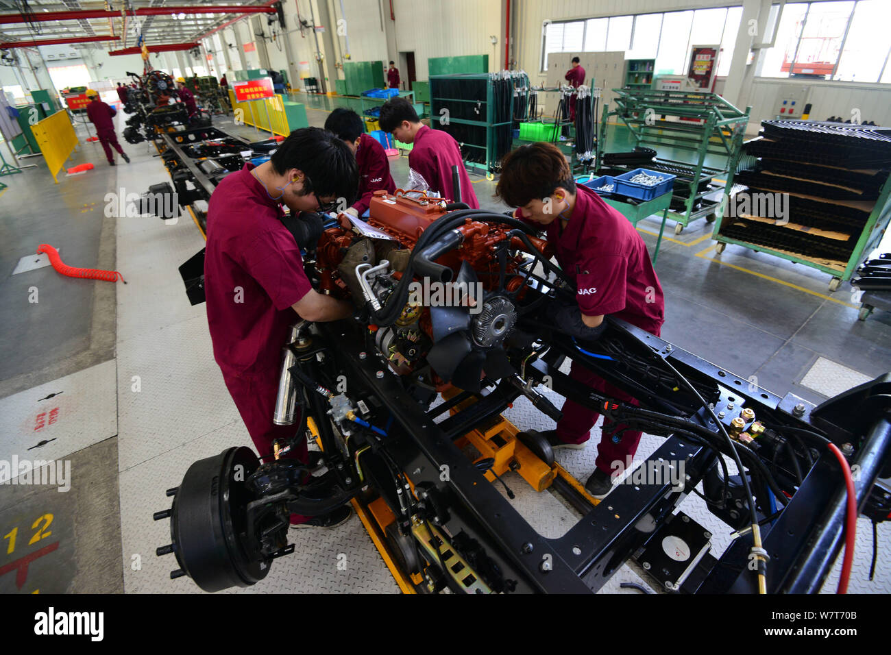 --FILE--Chinese workers assemble cars on the assembly line at an auto ...
