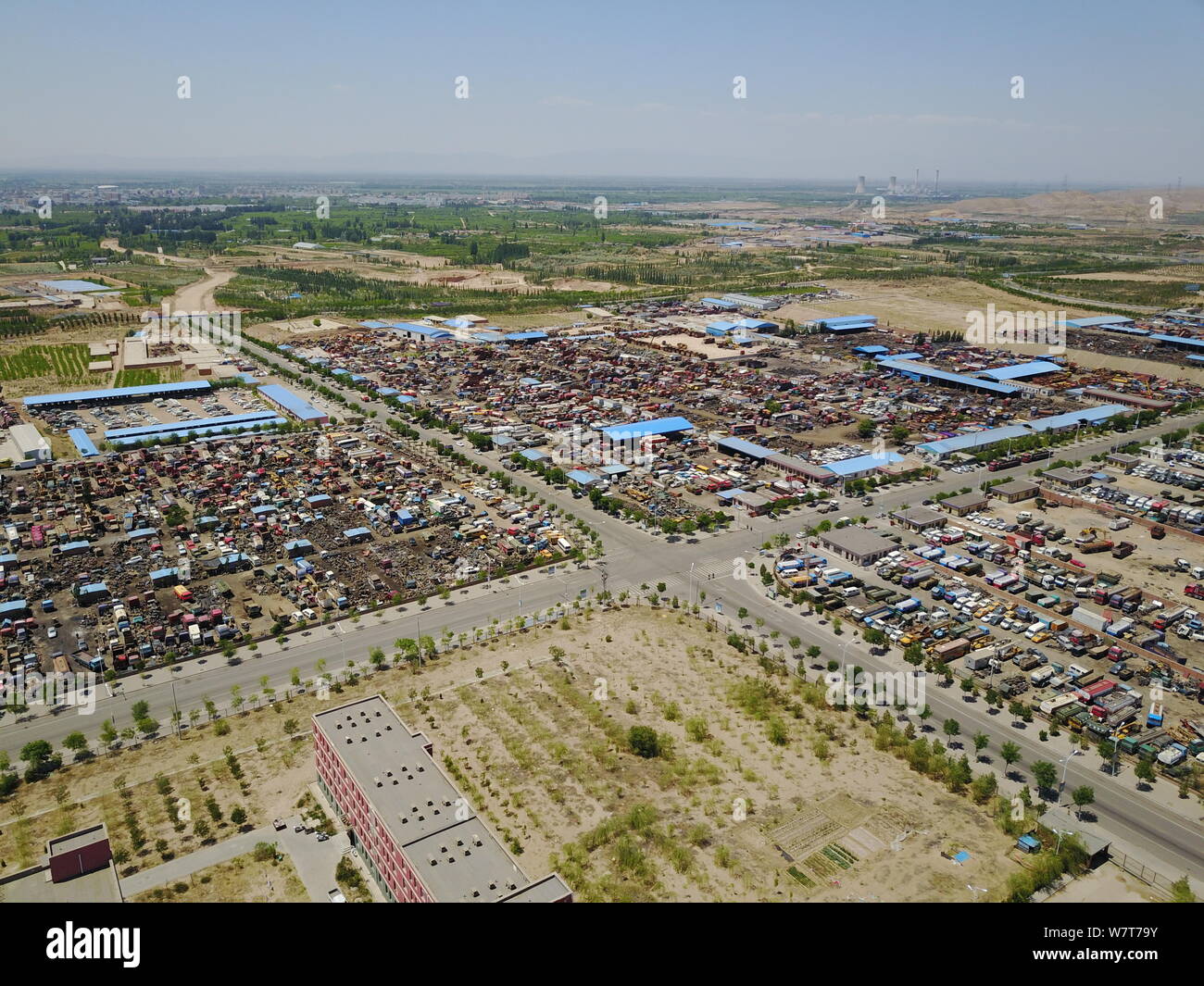 Aerial view of a junkyard piled up with scrapped vehicles in Lingwu ...