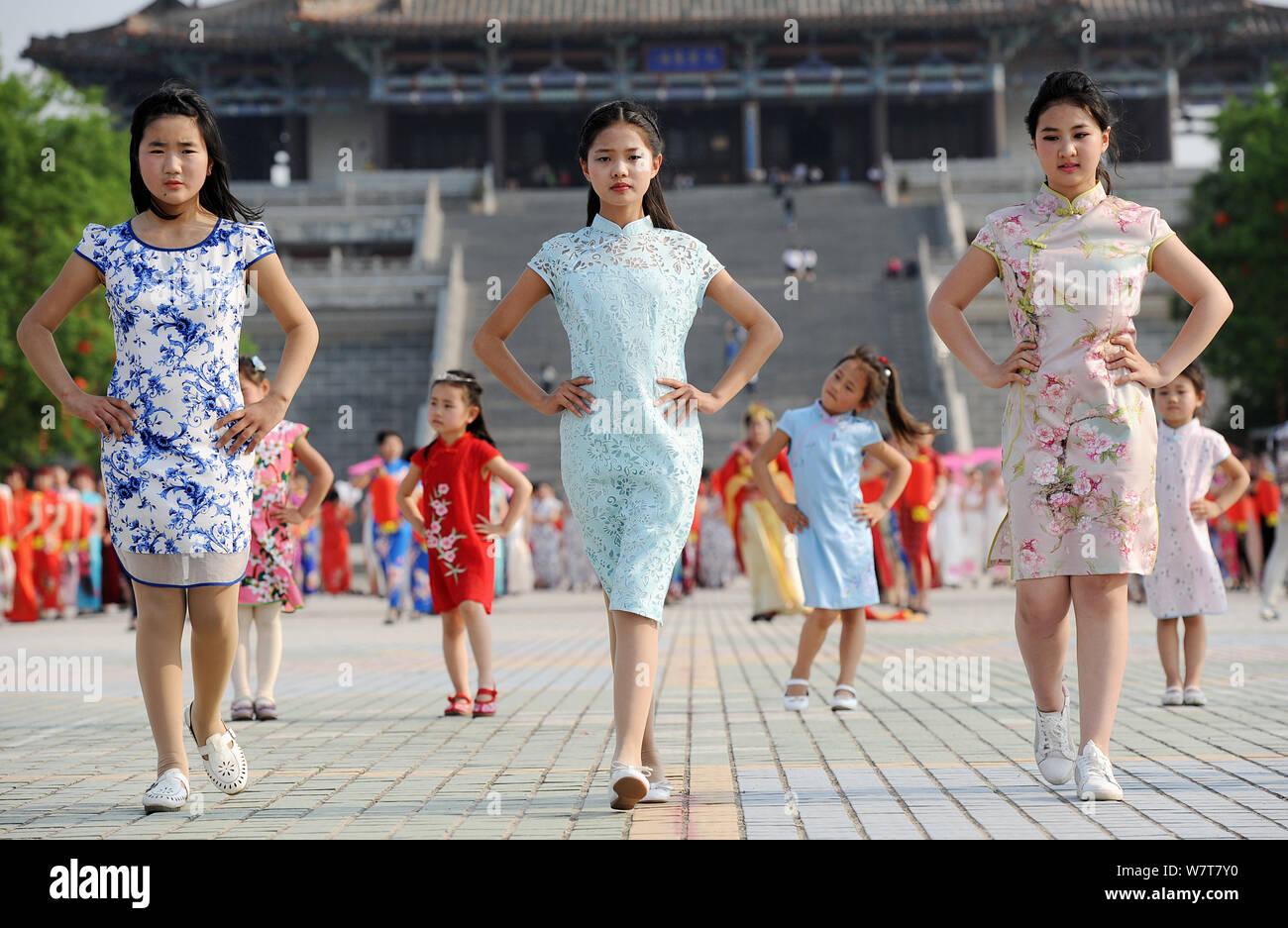 Women present cheongsam, a traditional Chinese women's dress also known ...