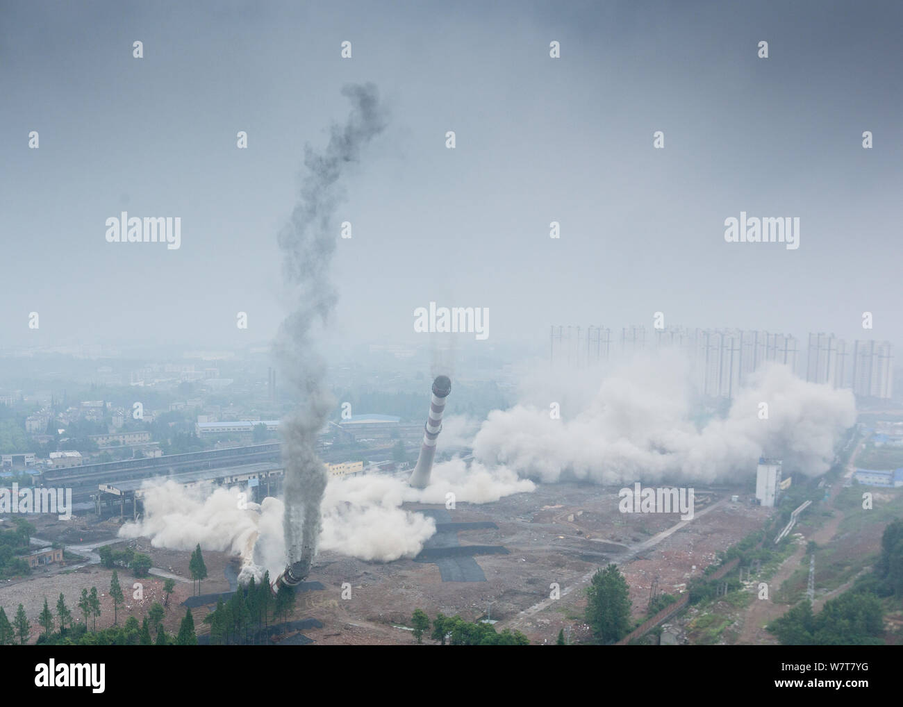 Two 180-meter-tall chimneys and a cooling tower are demolished by ...