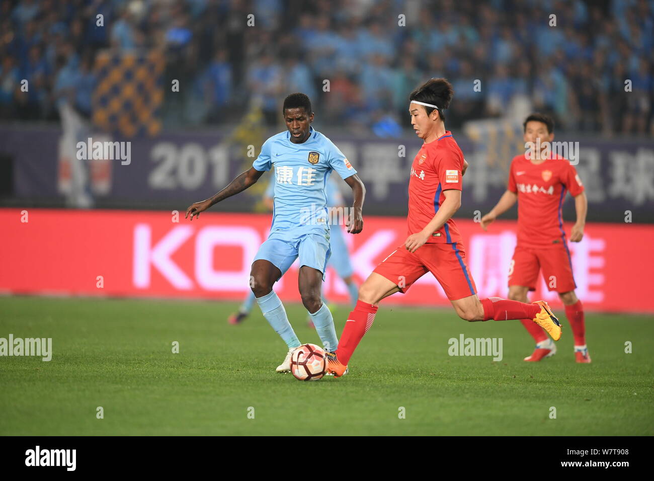 Brazilian football player Ramires, left, of Jiangsu Suning, challenges ...