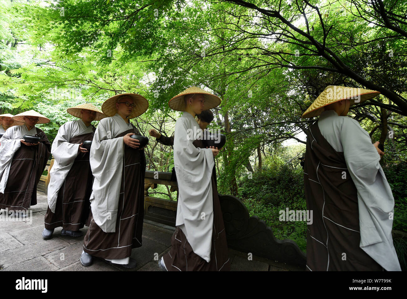 Chinese Buddhist monks holding alms bowls take part in a mendicants ...