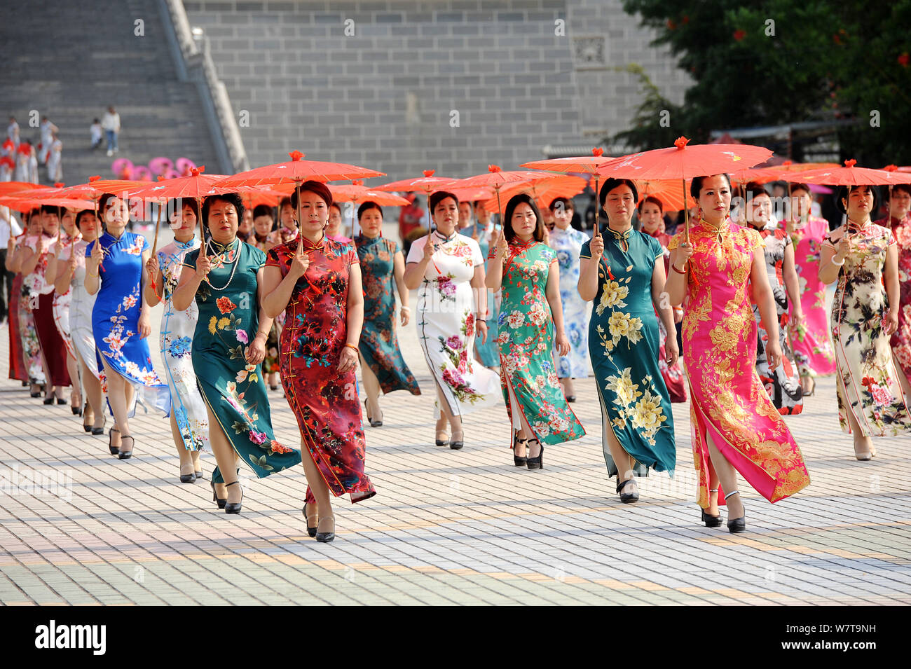 Women present cheongsam, a traditional Chinese women's dress also known ...