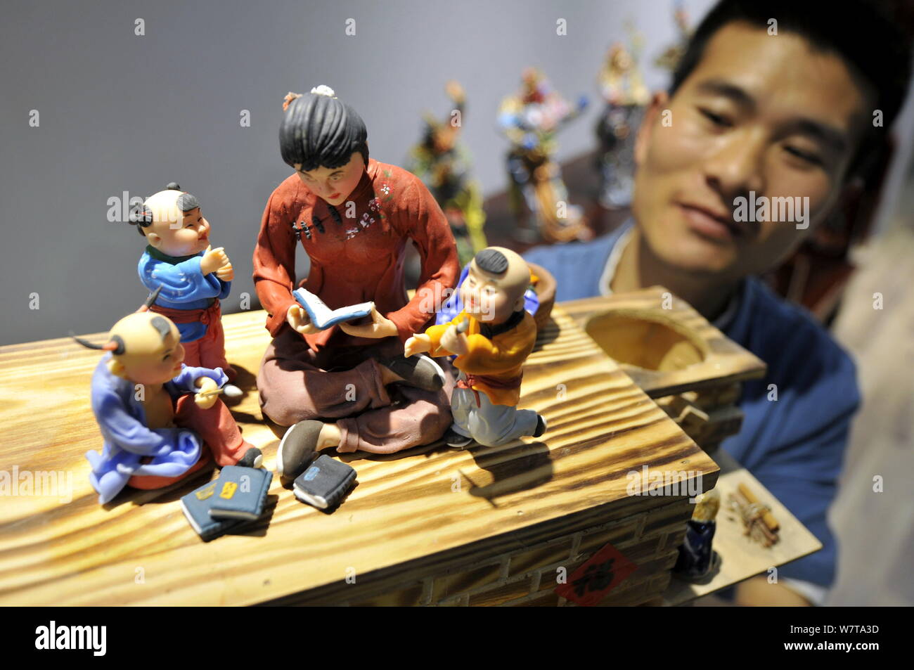 Chinese folk artist Han Hongyuan shows dough figurines made by himself ...