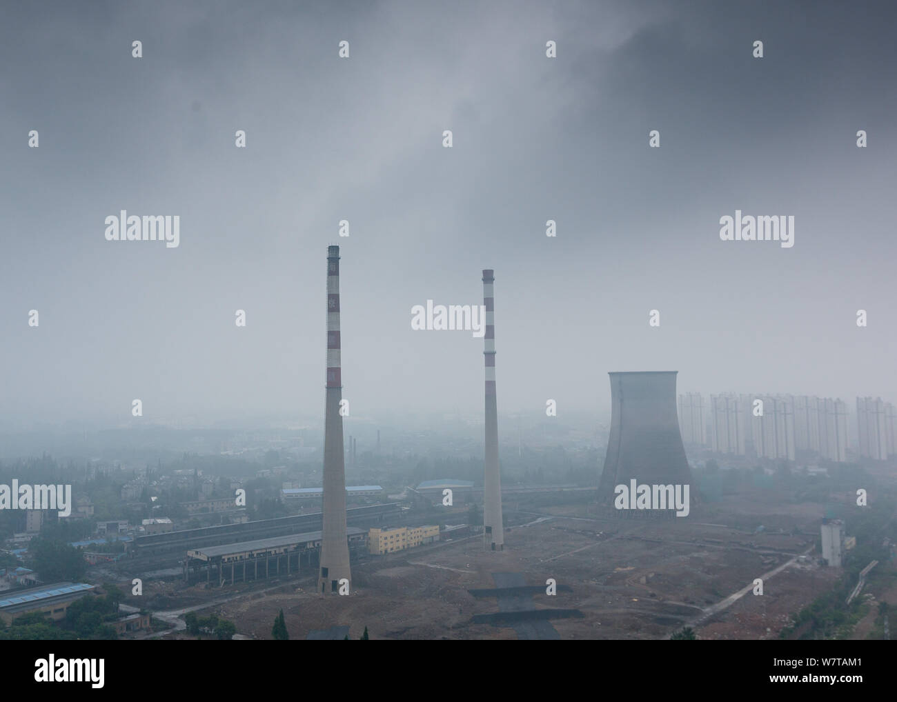 Two 180-meter-tall chimneys and a cooling tower are pictured before ...