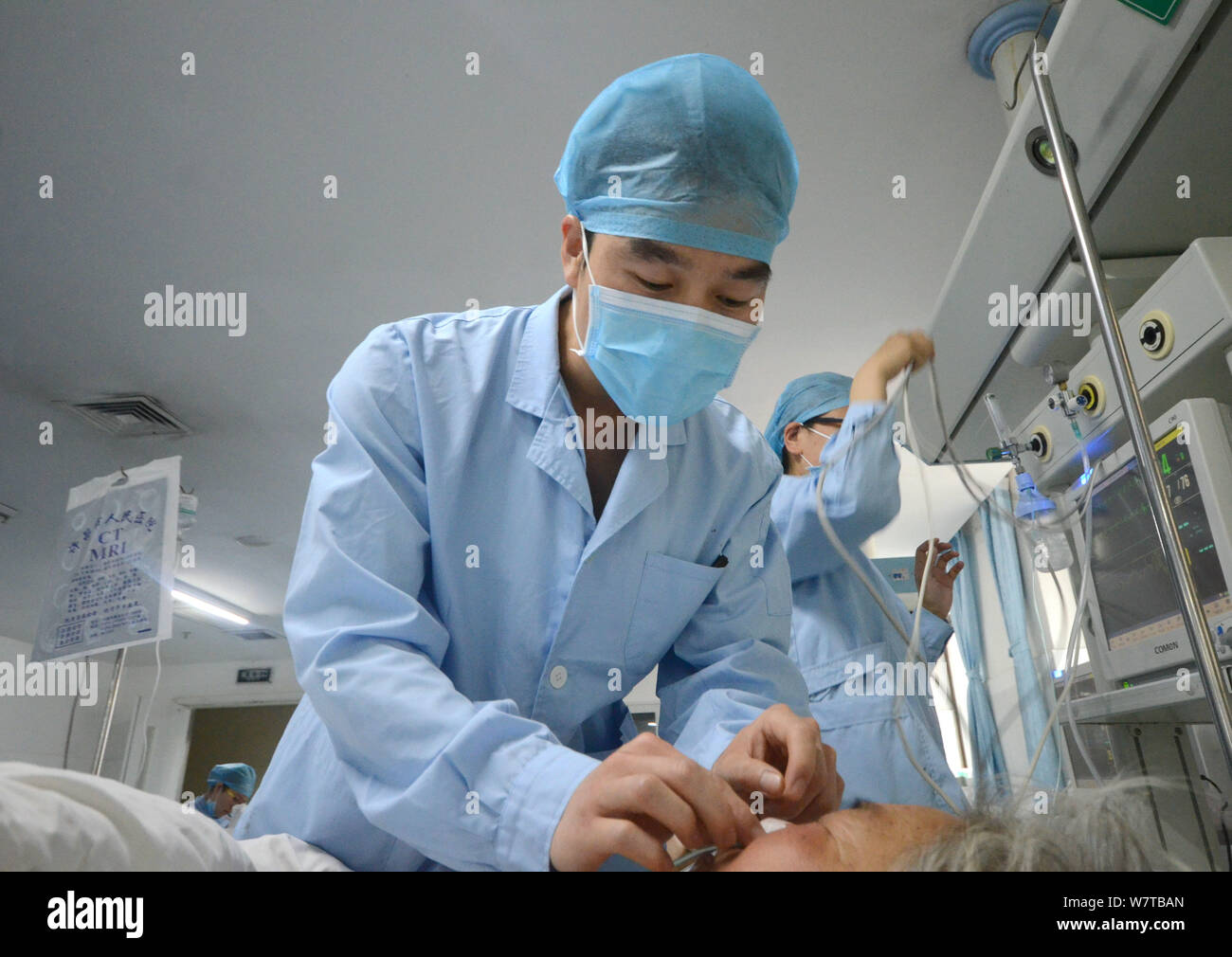 A male Chinese nurse Liang Shulei takes care of a patient in the ...