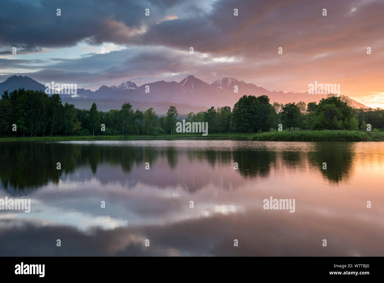 Lake with clouds reflected with High Tatras Mountains at dawn ...