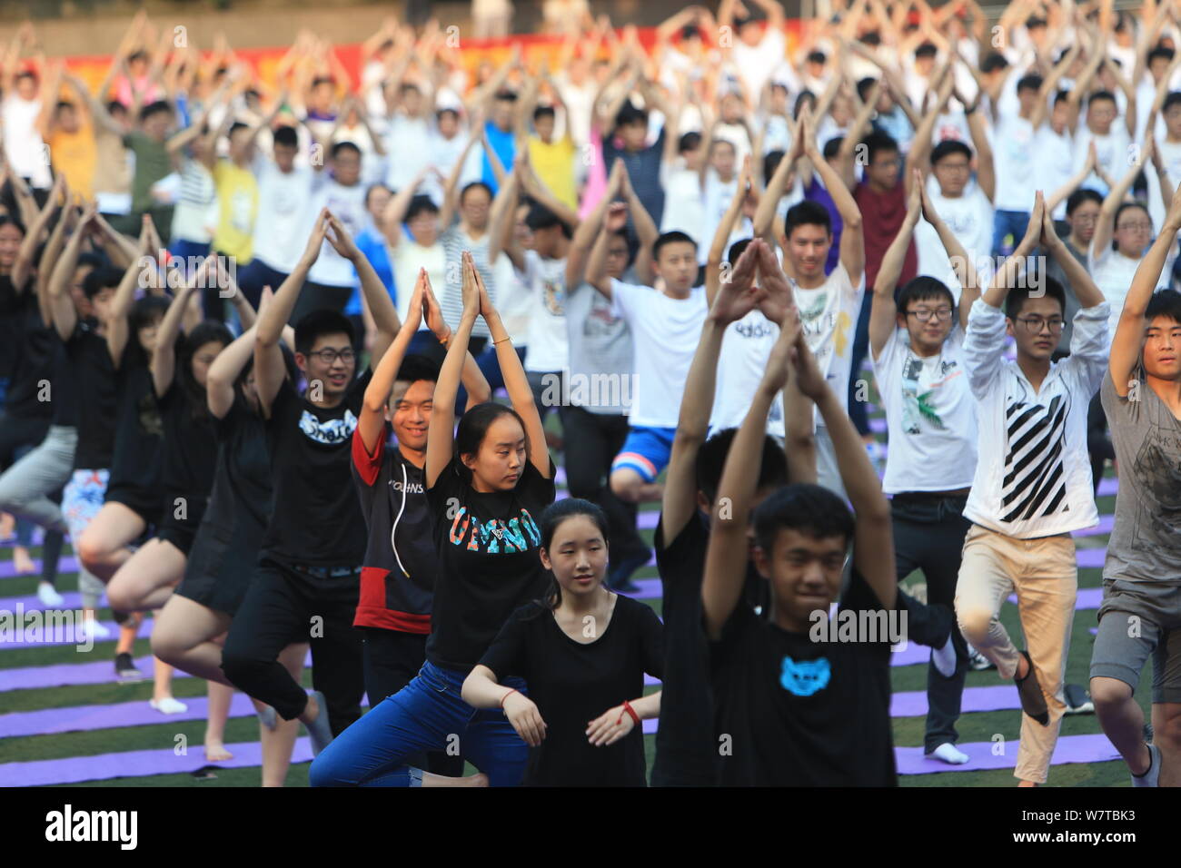 Chinese students practice yoga in group to ease tension and anxiety ...