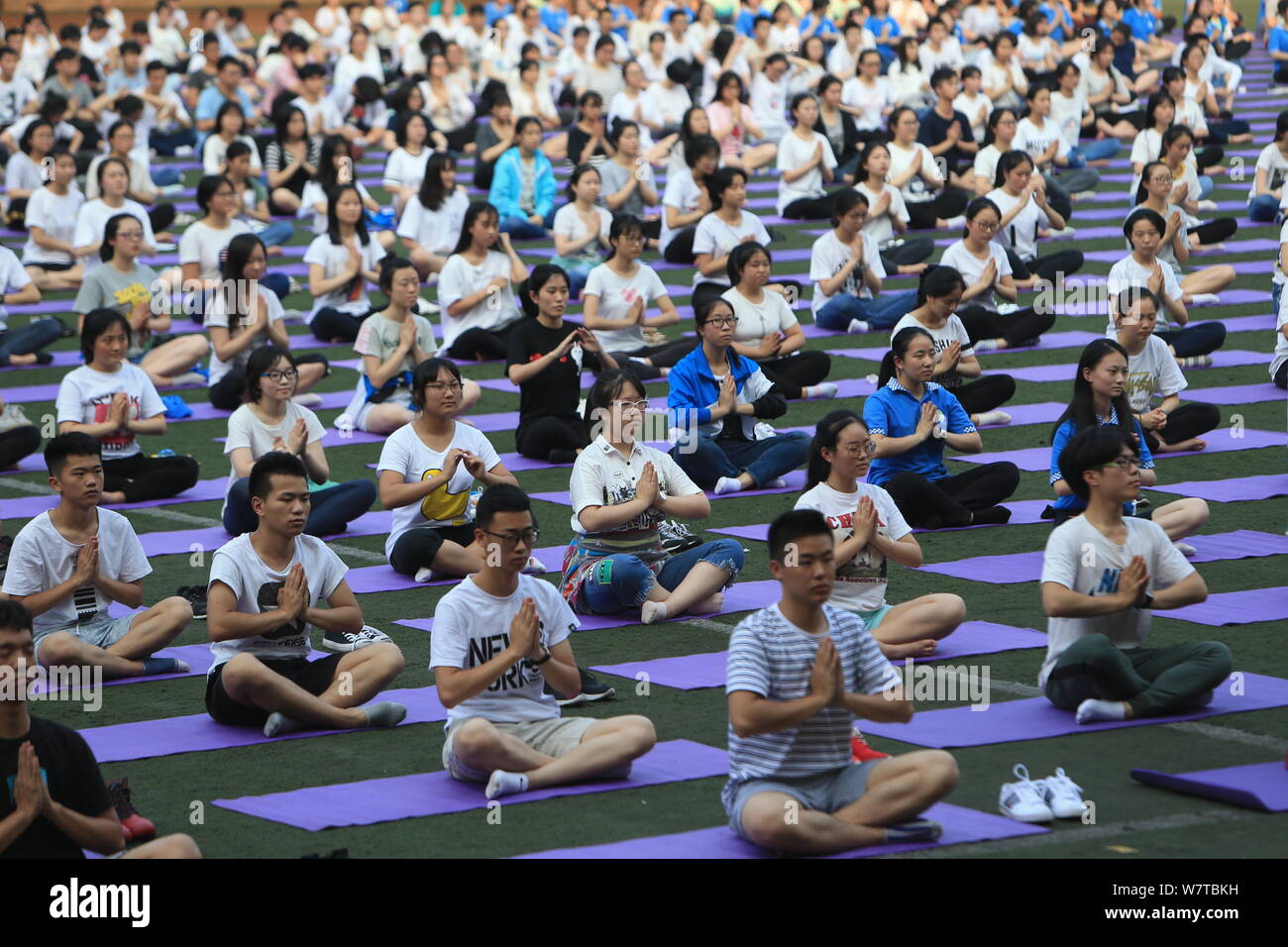Chinese students practice yoga in group to ease tension and anxiety ...