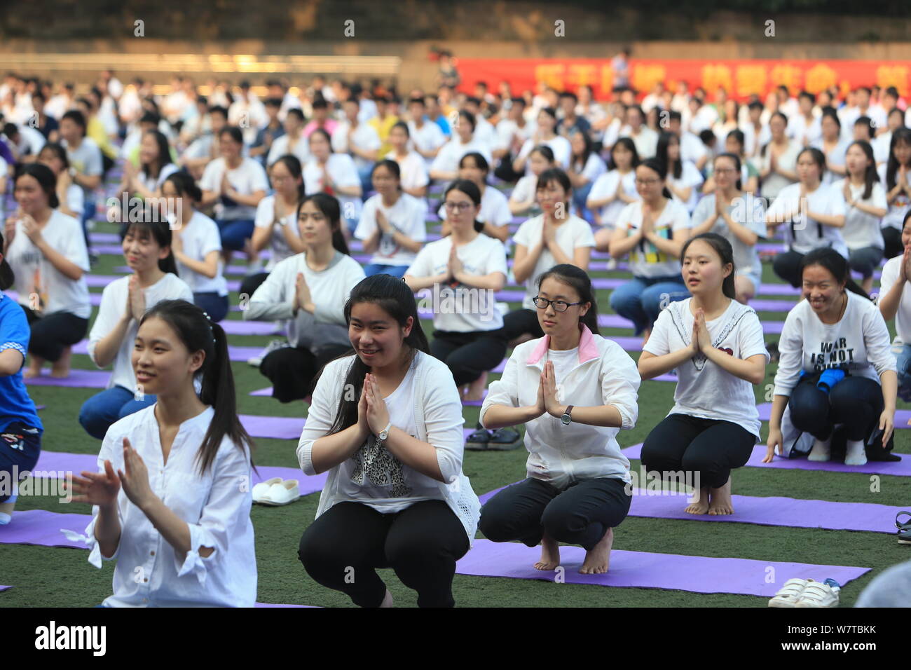 Chinese students practice yoga in group to ease tension and anxiety ...