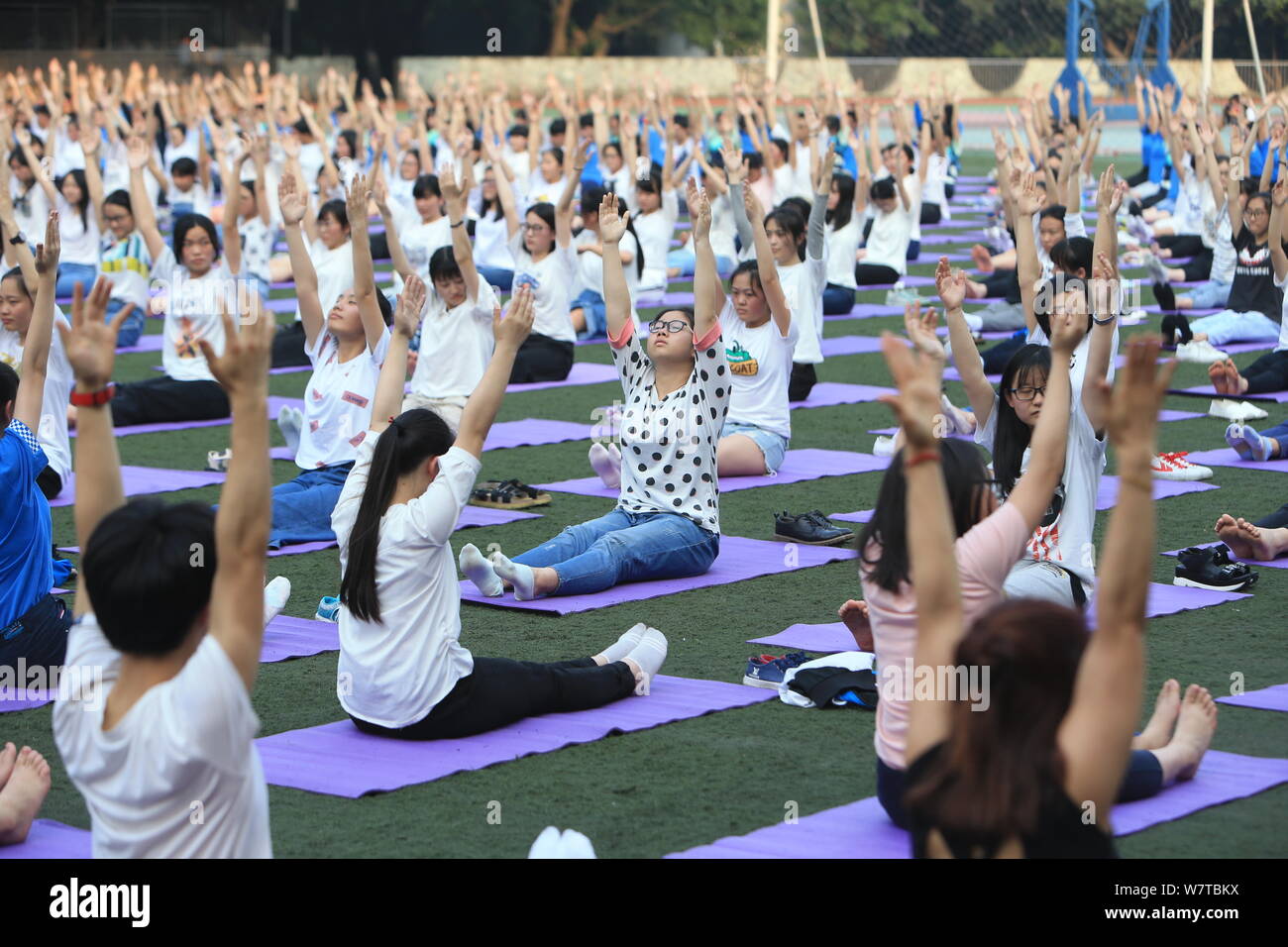 Chinese students practice yoga in group to ease tension and anxiety ...