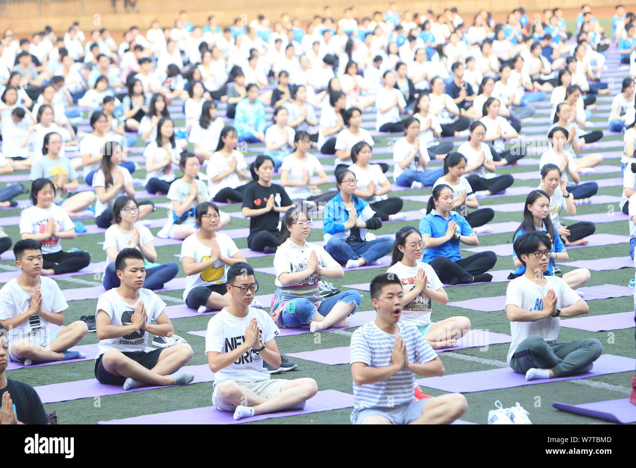 Chinese students practice yoga in group to ease tension and anxiety ...
