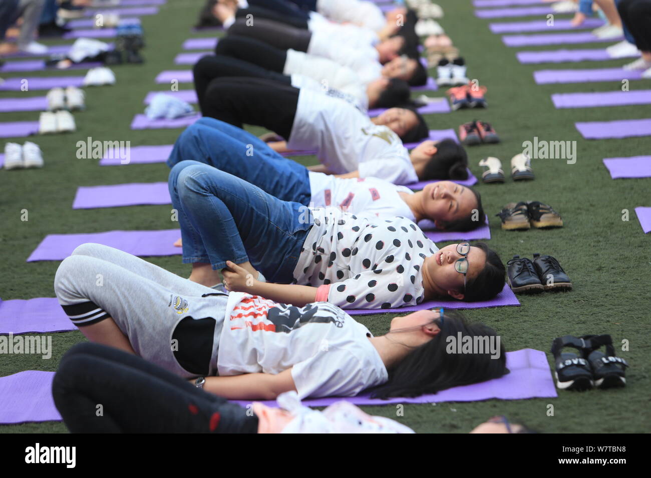 Chinese students practice yoga in group to ease tension and anxiety ...