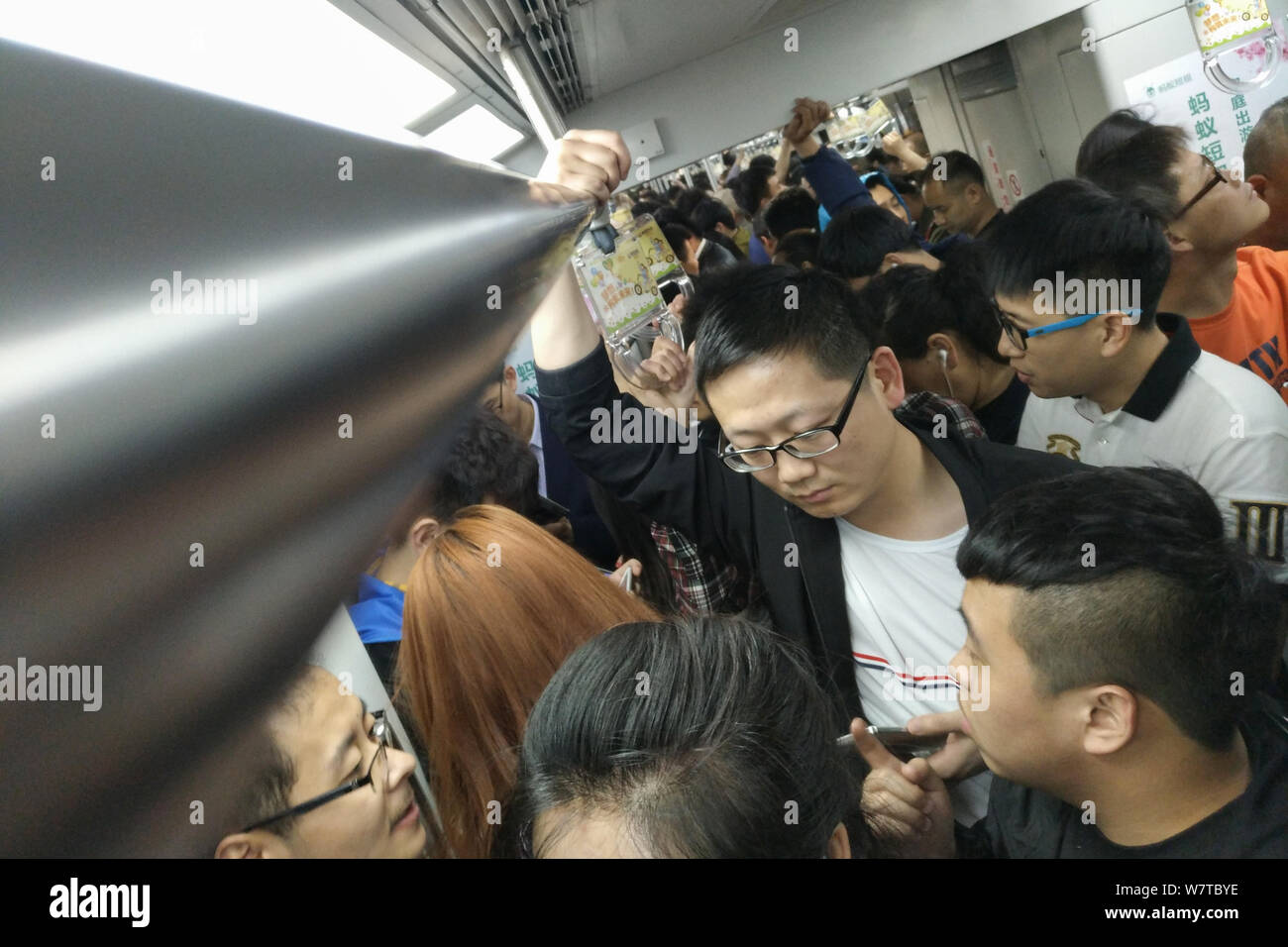 Chinese man Yang Wenhao, 28, looks at his smartphone in a subway train ...