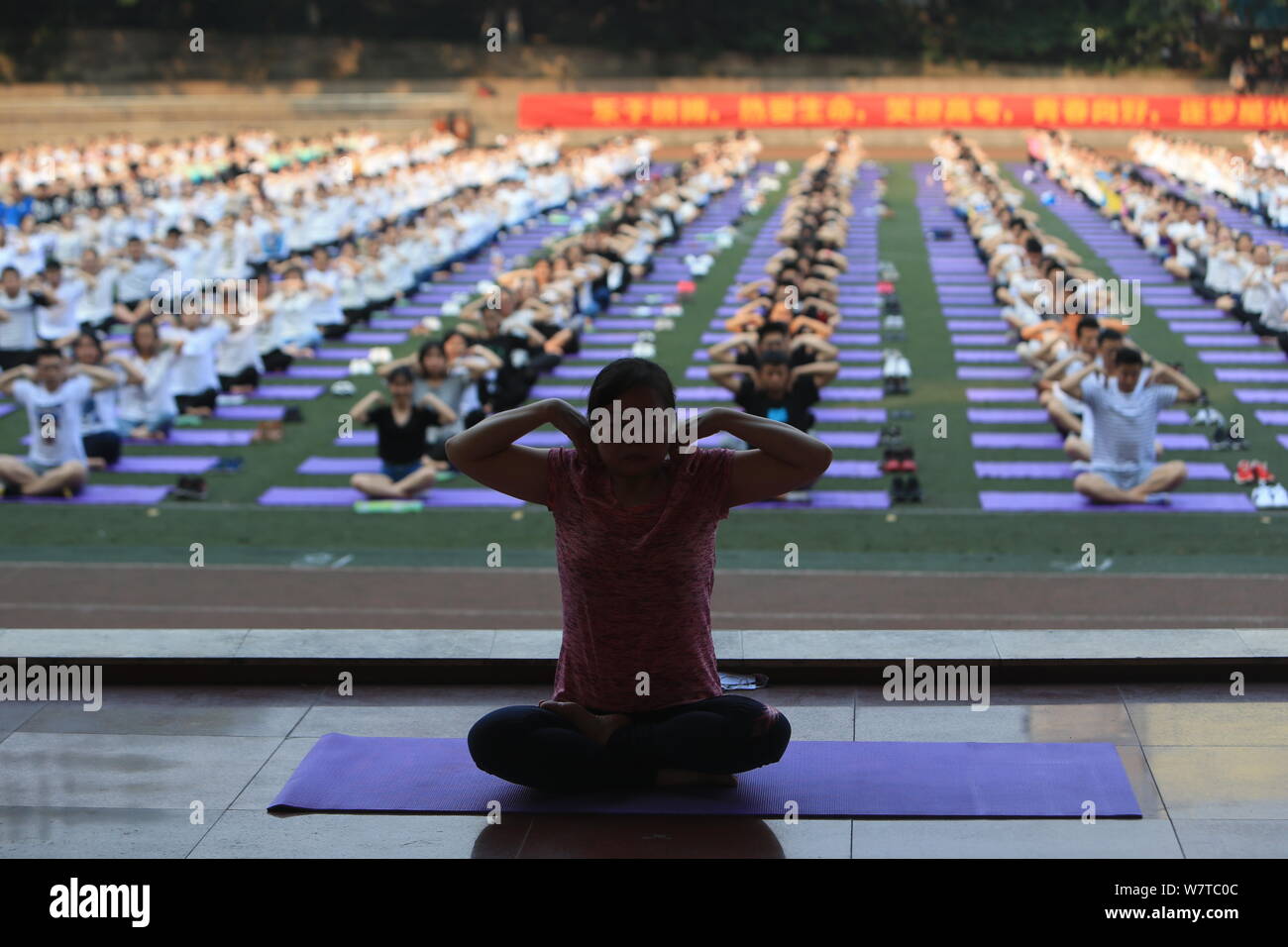 Chinese students practice yoga in group to ease tension and anxiety ...