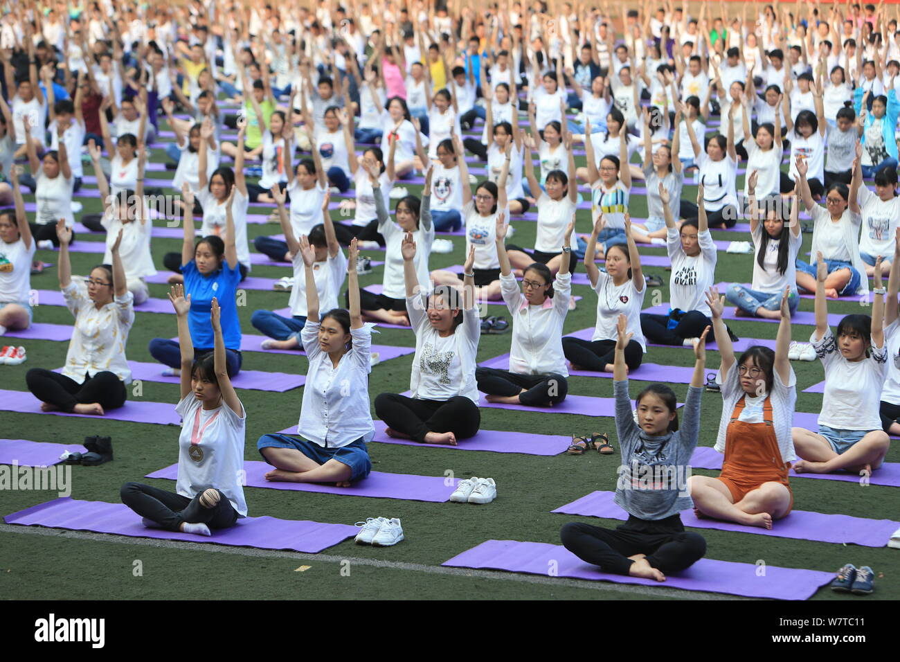 Chinese students practice yoga in group to ease tension and anxiety ...