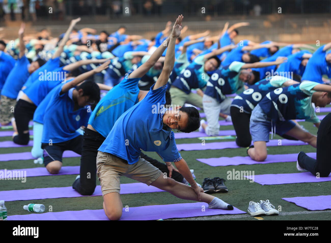 Chinese students practice yoga in group to ease tension and anxiety ...