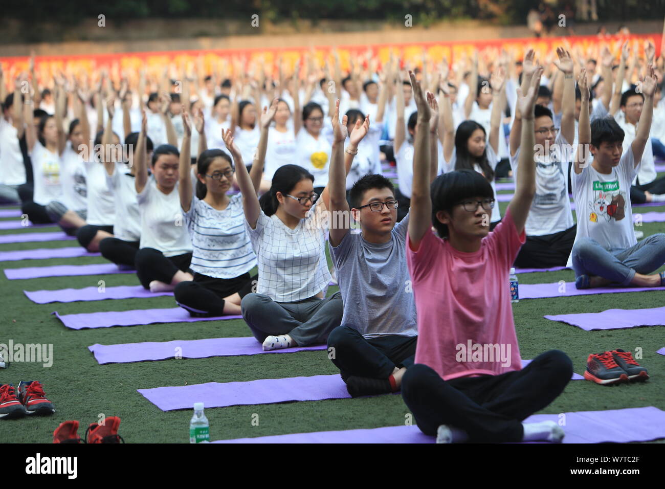 Chinese students practice yoga in group to ease tension and anxiety ...