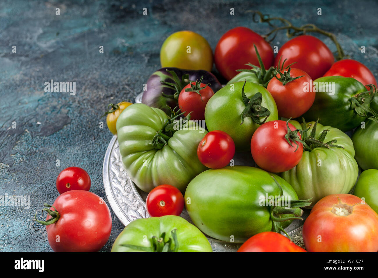 Various types, colors and shapes of tomatoes on a silver plate Stock ...