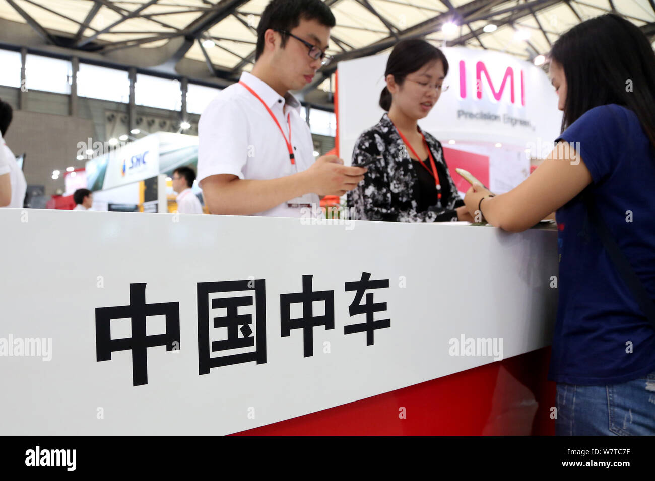 --FILE--Chinese employees are seen at the stand of CRRC (China Railway ...