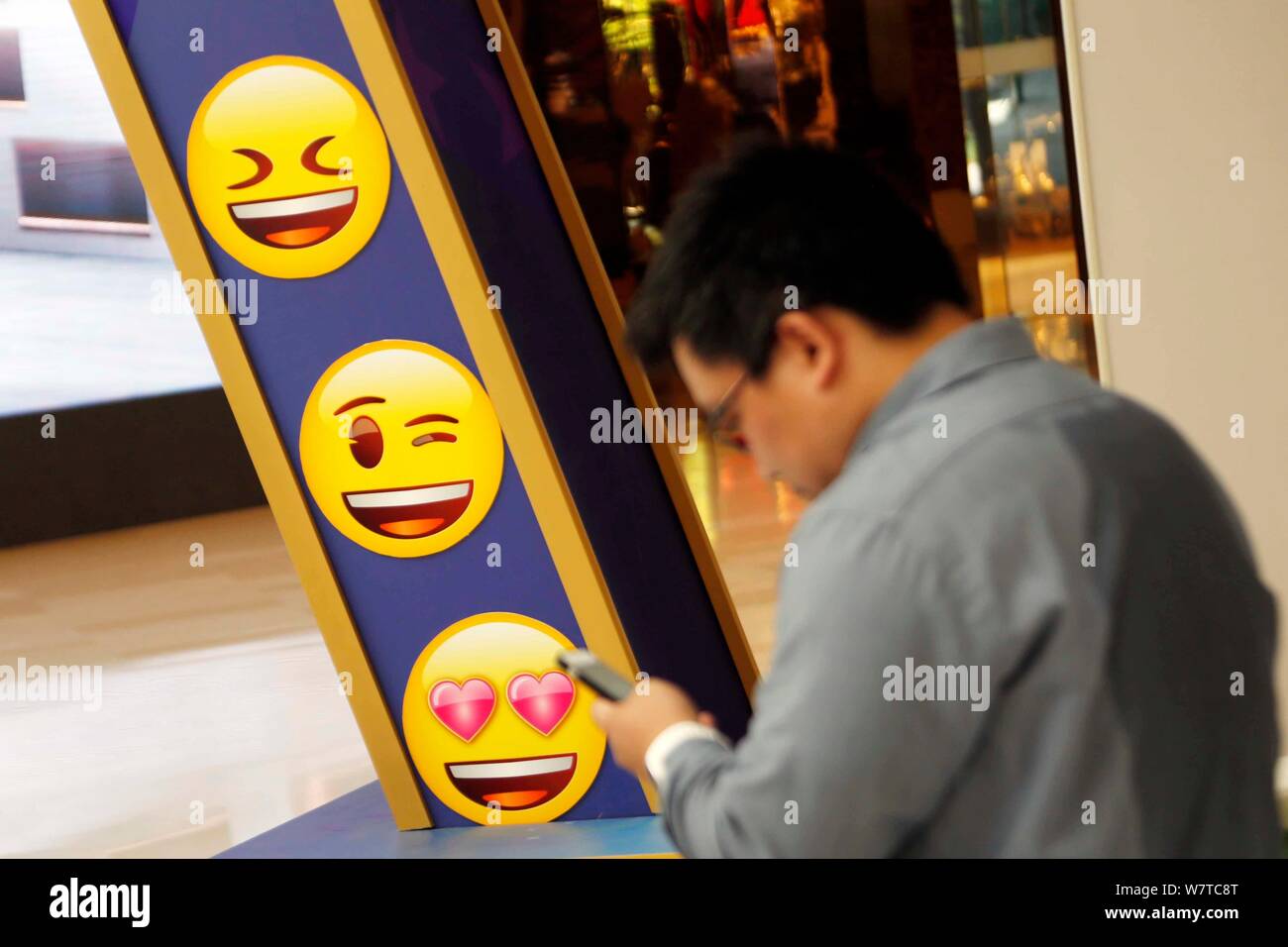 A visitor is pictured during an exhibition featuring emojis in a ...
