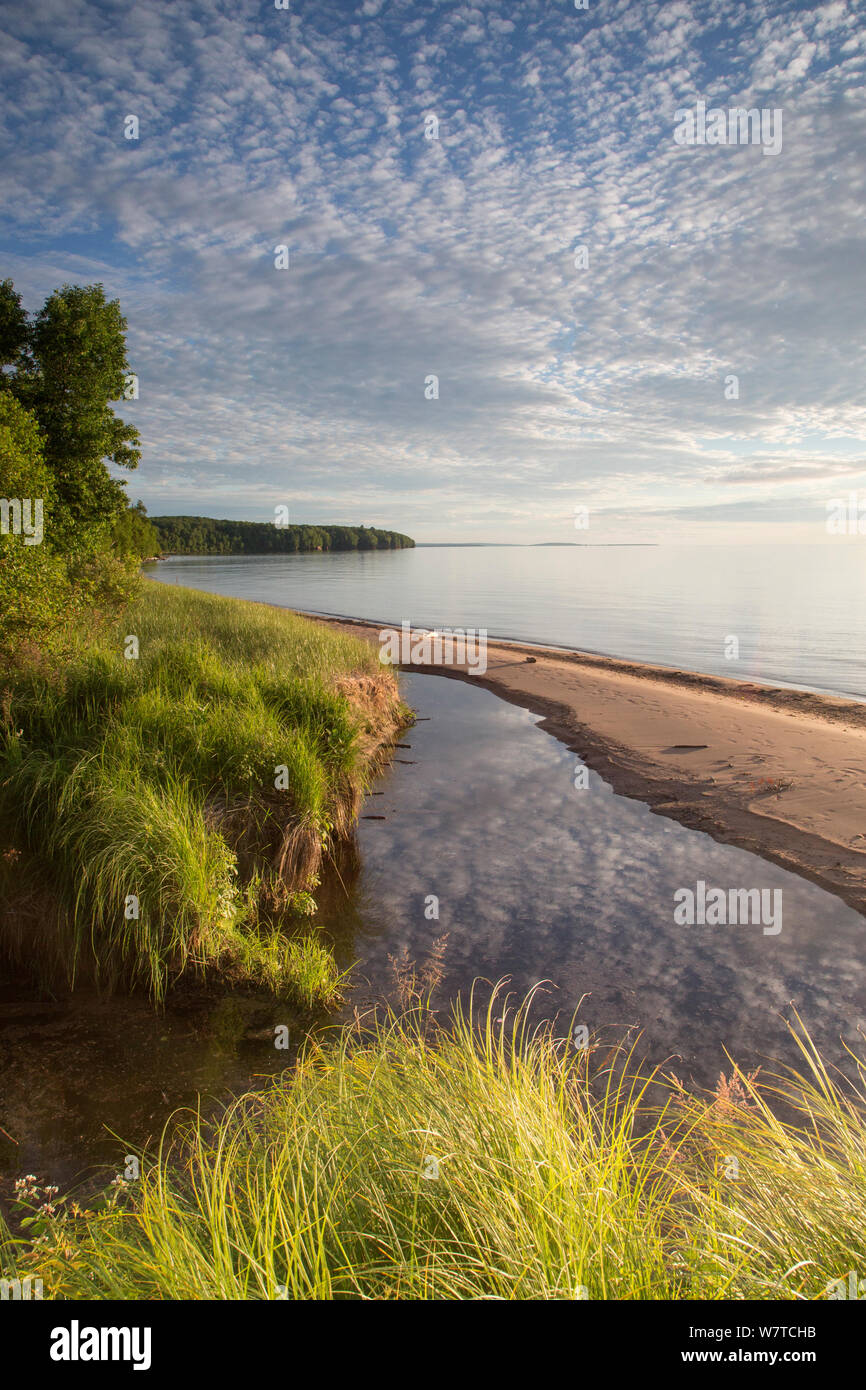 A beach at the edge of Lake Superior in the late afternoon. Apostle ...