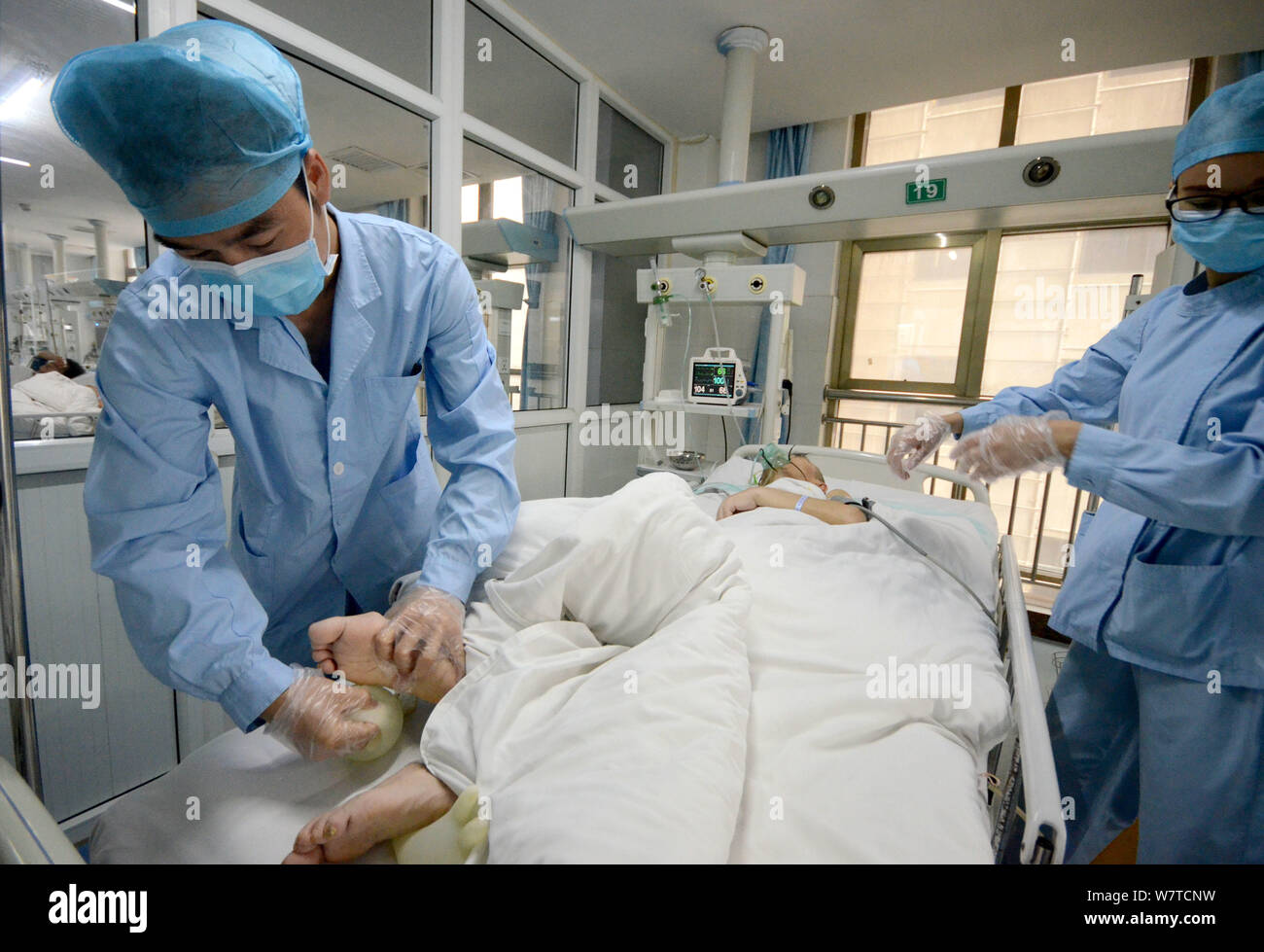 A male Chinese nurse Liang Shulei takes care of a patient in the ...