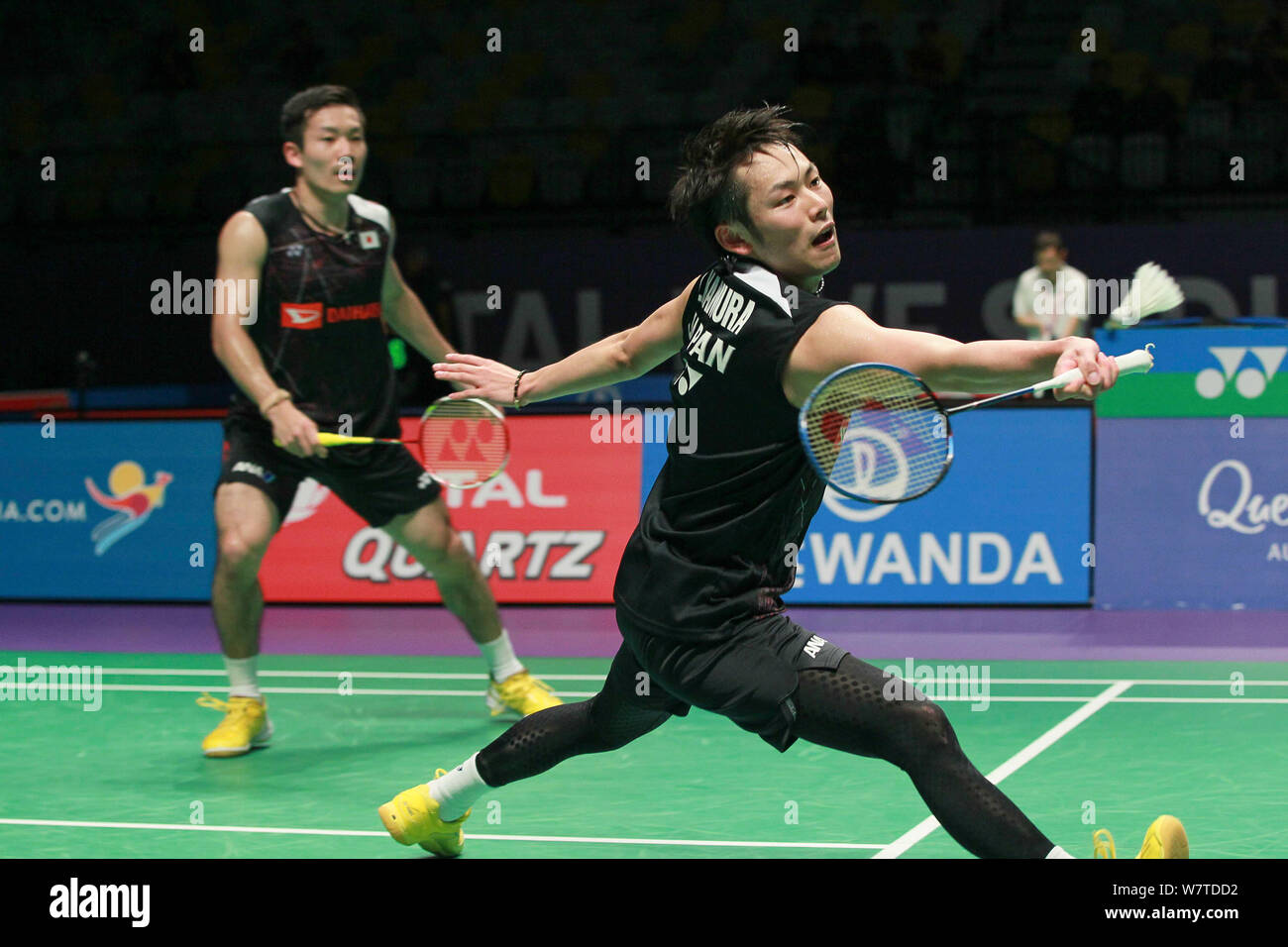 Takeshi Kamura, front, returns a shot as he and Keigo Sonoda of Japan ...