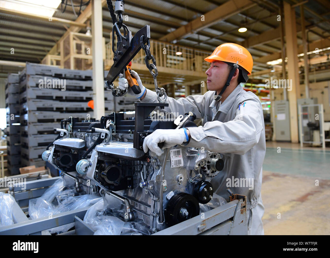 --FILE--Chinese workers assemble engines for autos at a plant of ...
