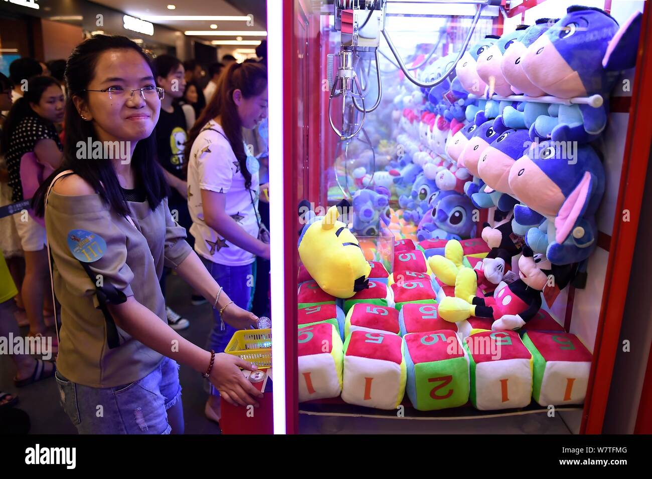 Competitors take part in a doll-grabbing competition at N1 shopping ...
