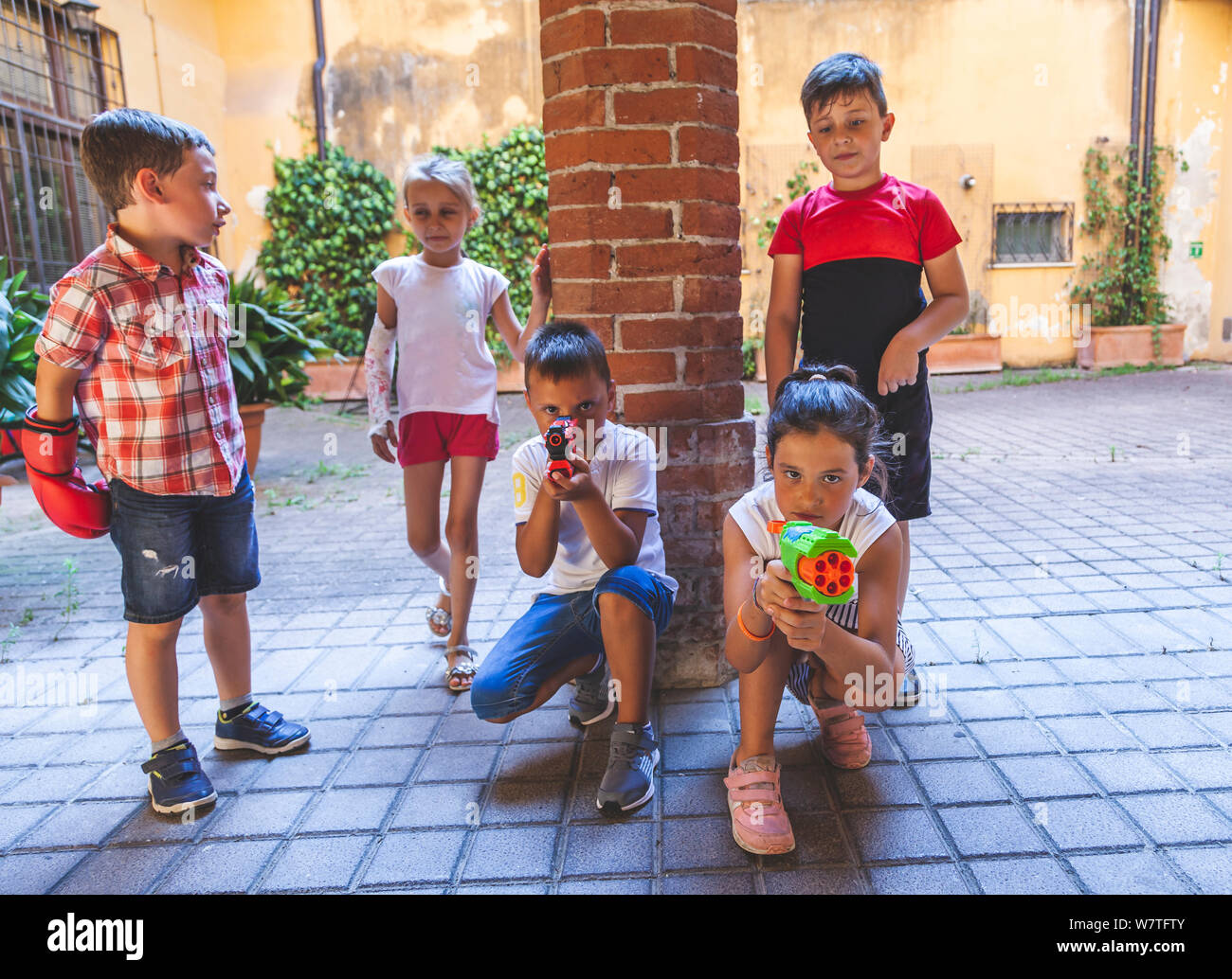 group of little boys of different ages having fun and playing together ...