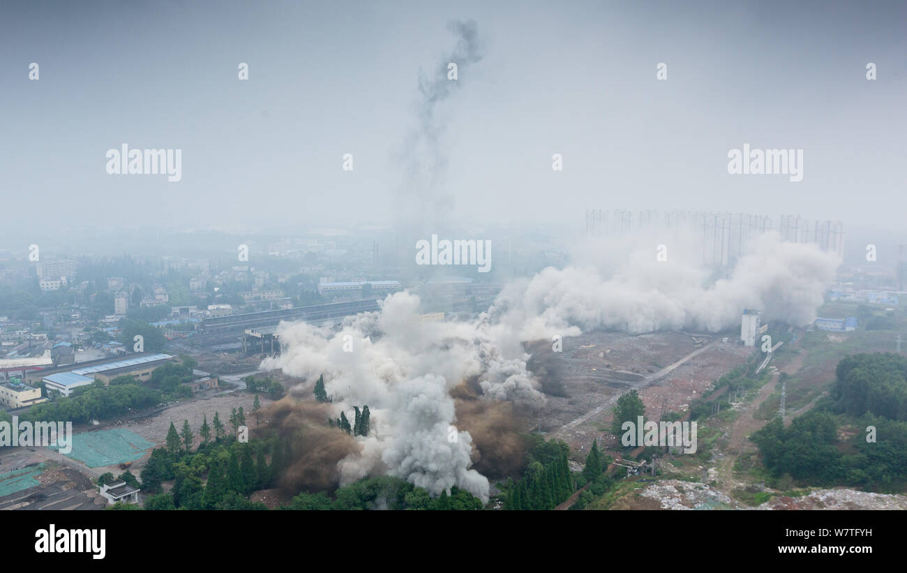 Two 180-meter-tall chimneys and a cooling tower are demolished by ...